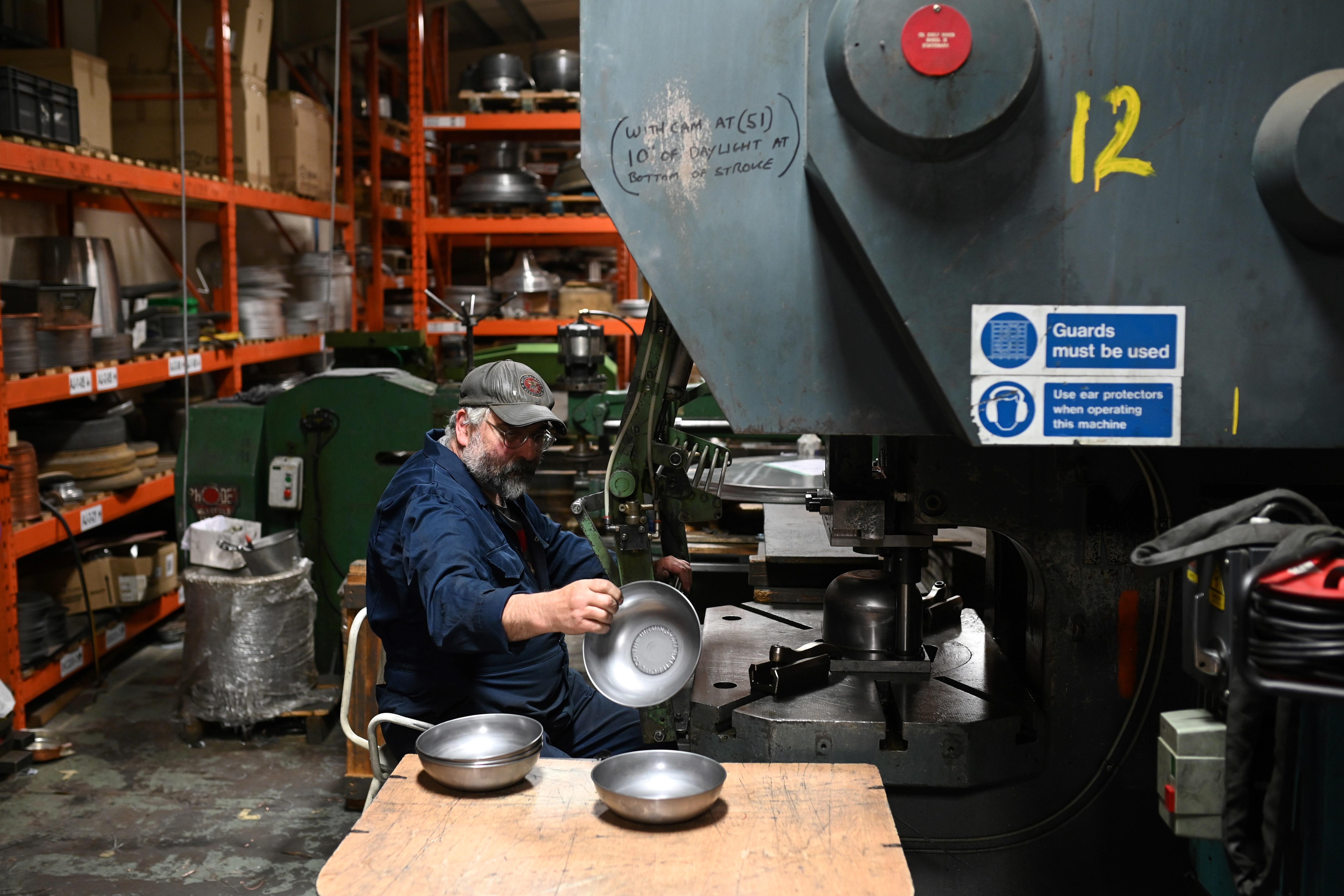 World factory activity shrinks as slowing growth takes toll