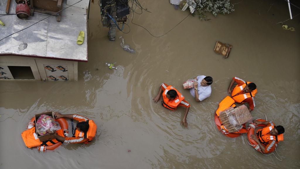 Races to open flood gates as river surge halts India's capital