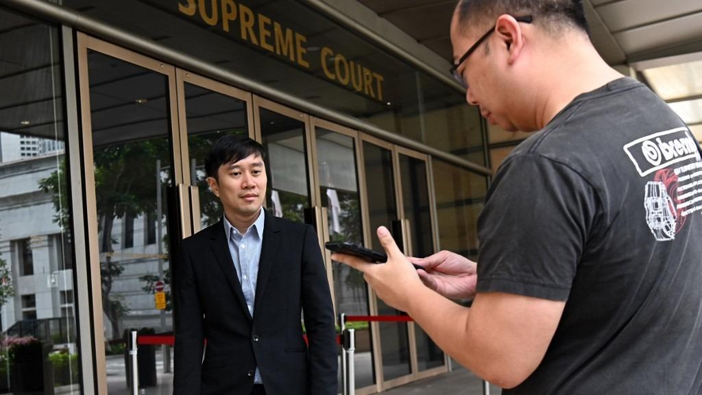 S'pore activist faces fine over one-man smiley face sign protest
