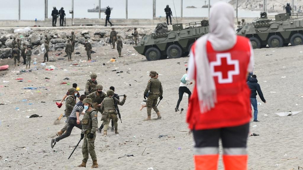 Spain vows to restore order after thousands swim into Ceuta